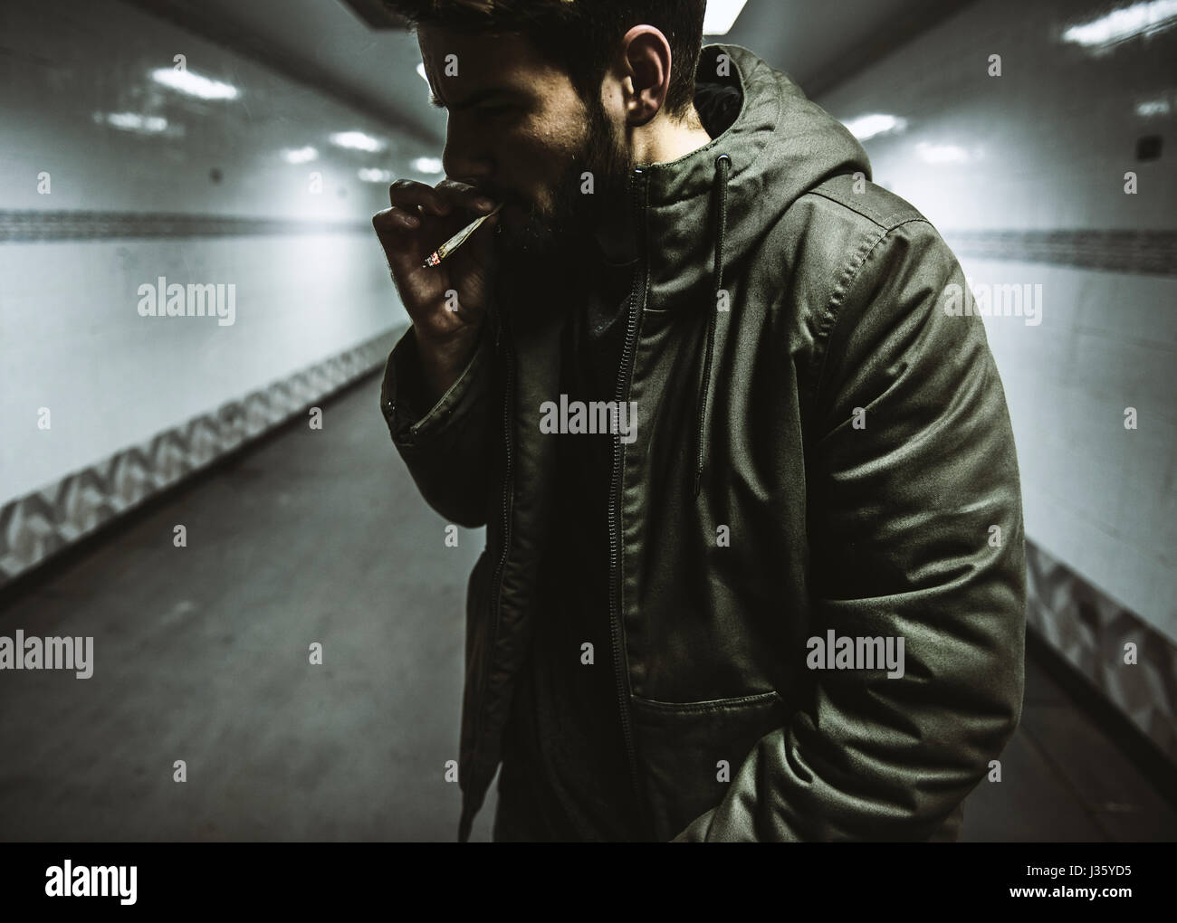 Homeless man smoking cigarette hi-res stock photography and images - Alamy
