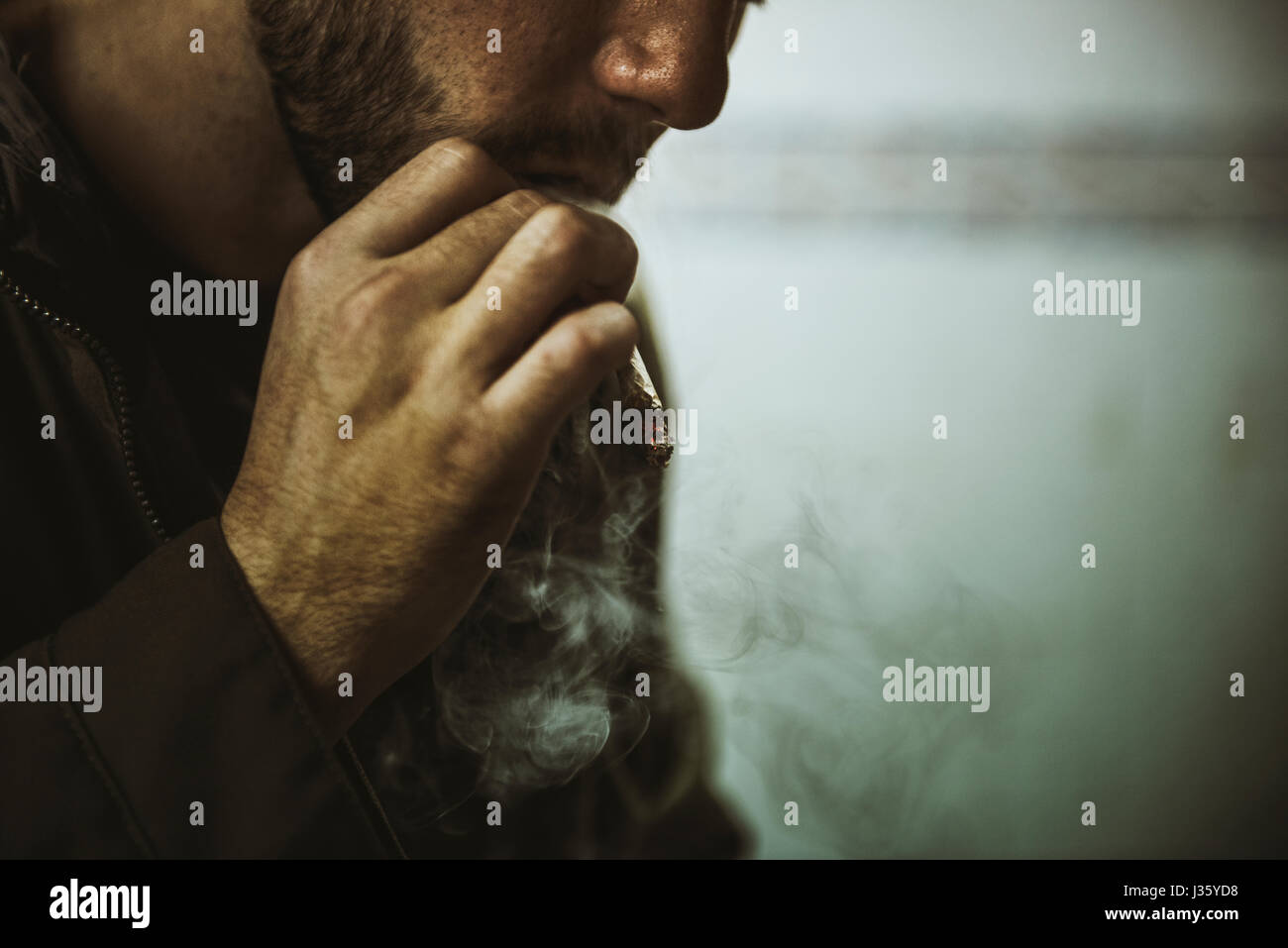 Homeless man smoking cigarette hi-res stock photography and images - Alamy