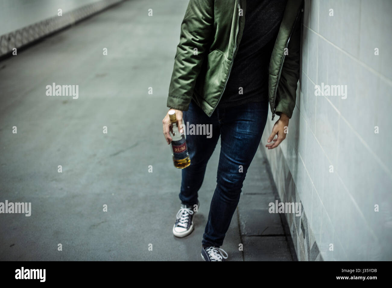 Homeless Alcoholism Man Holding Liquor Bottle Stock Photo - Alamy