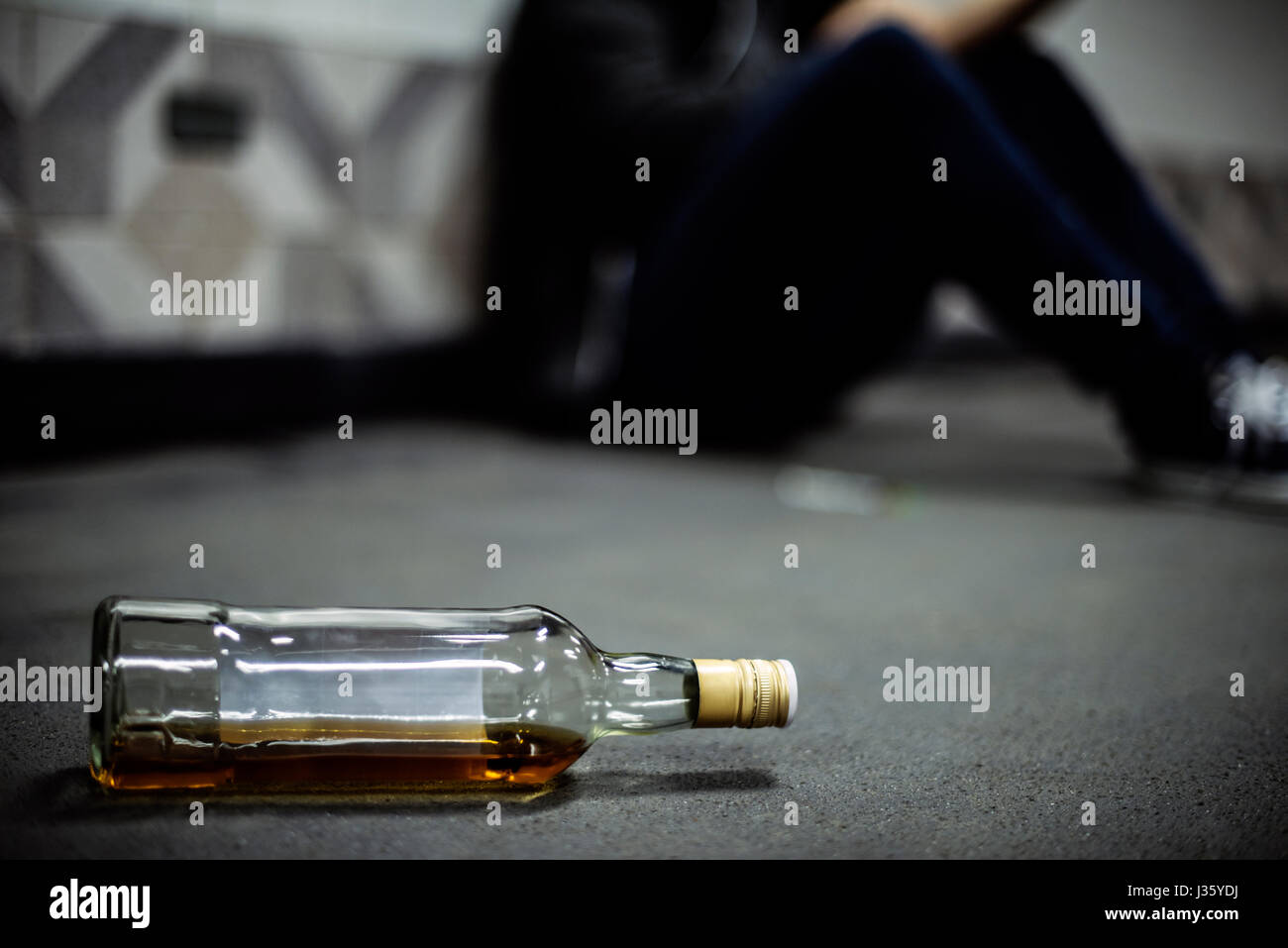 Liquor Alcohol Bottle Lying on The Floor Stock Photo - Alamy