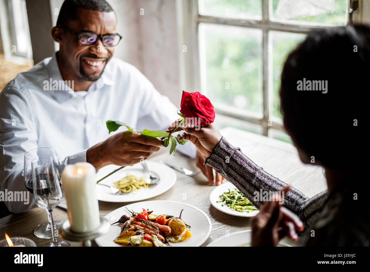 Giving a rose to his date hi-res stock photography and images - Alamy