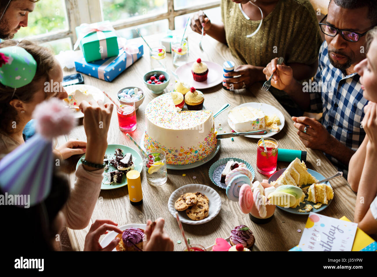 People Eating Cake on Birthday Party Celebration Stock Photo - Alamy