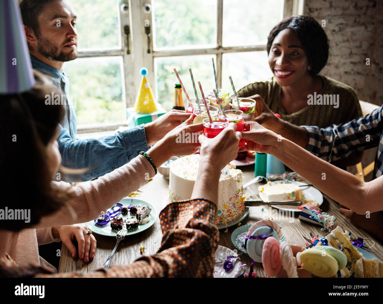 People Clinging Drinks Together on Birthday Party Stock Photo - Alamy