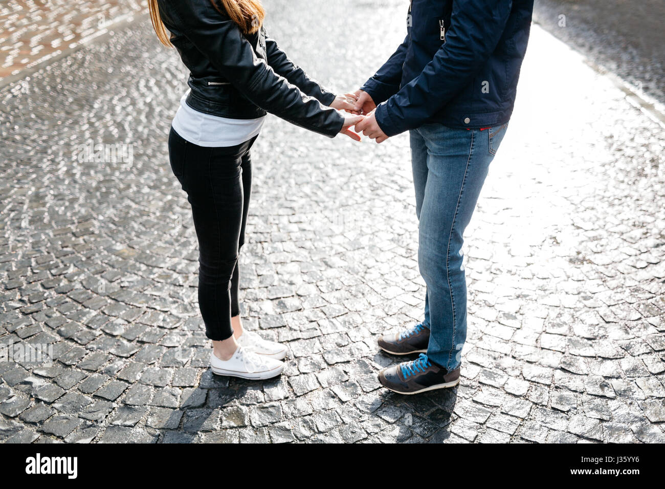 Cropped image of a couple holding hands and facing each other Stock ...