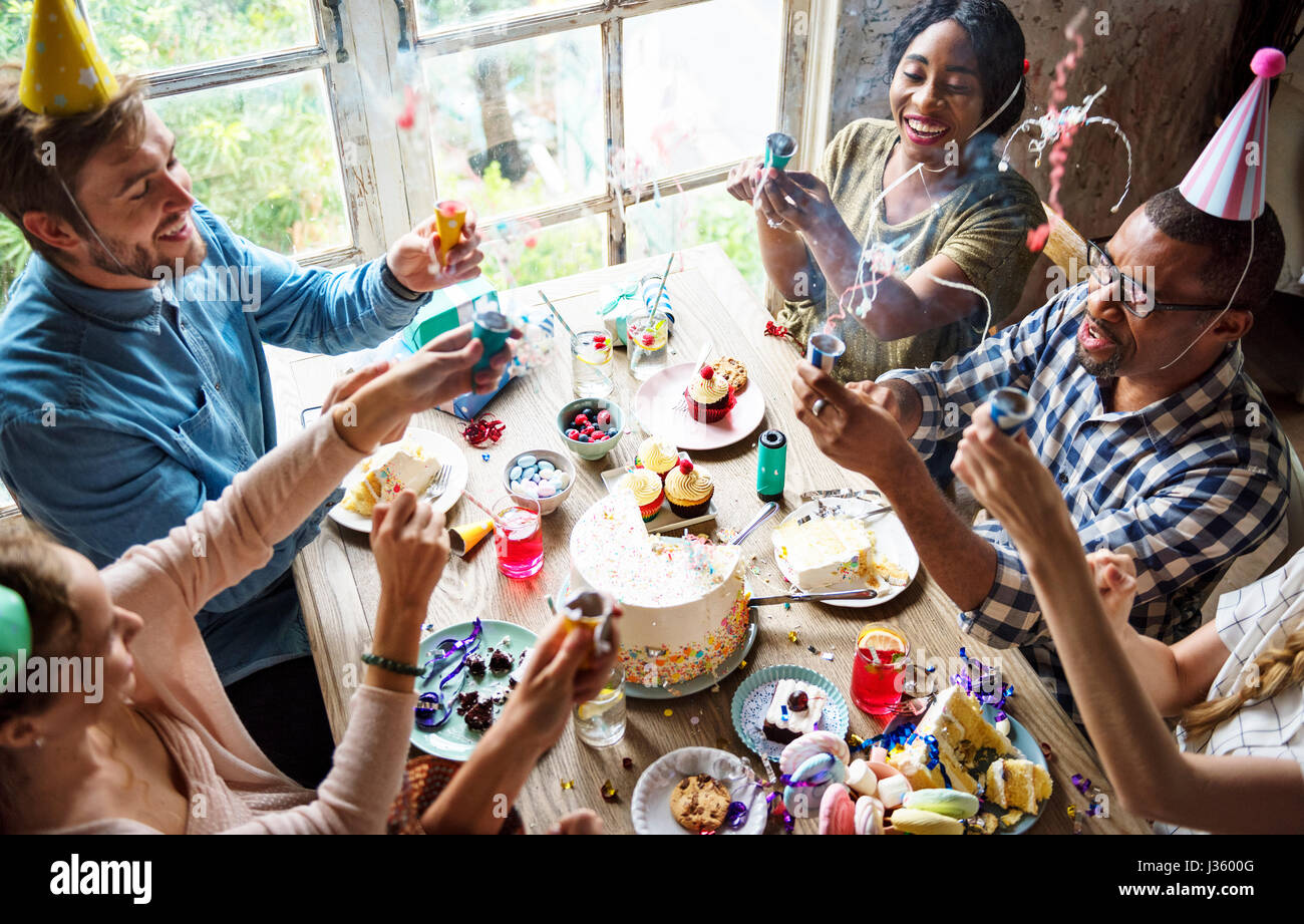 People Using Party Popping on Friend Birthday Celebration Stock Photo ...
