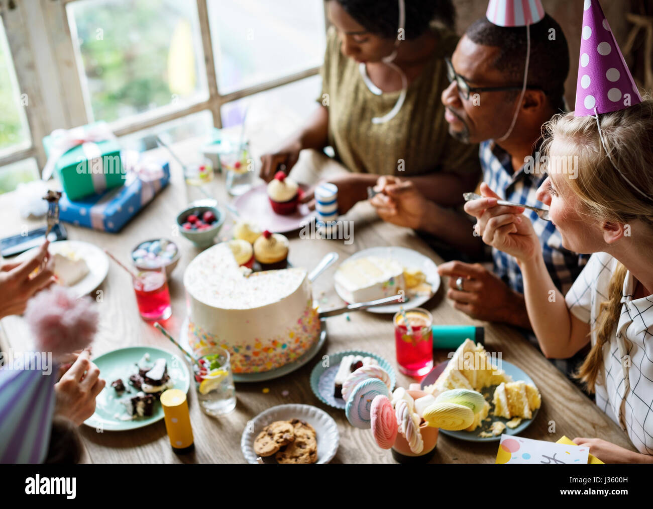 People Eating Cake on Birthday Party Celebration Stock Photo - Alamy