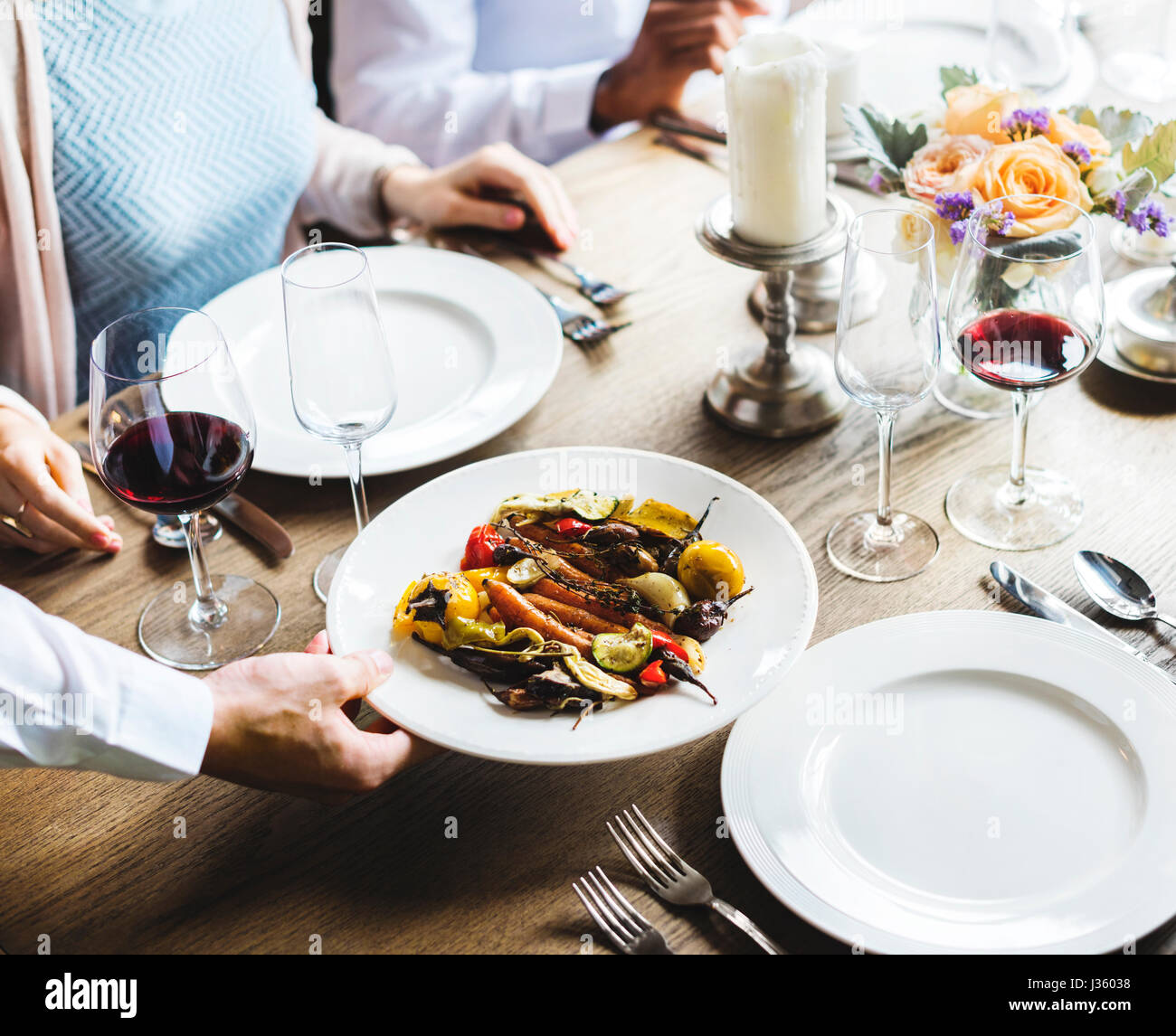 Waiter Serving Food Main Dish to Customers Stock Photo - Alamy