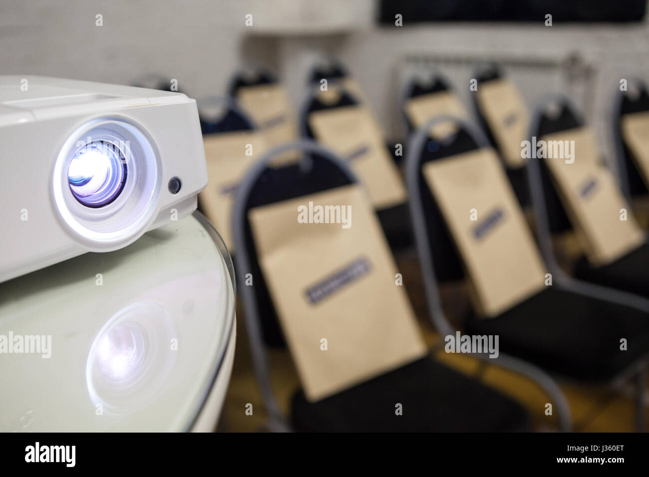 Projector on office table ready for presentation with chairs in ...