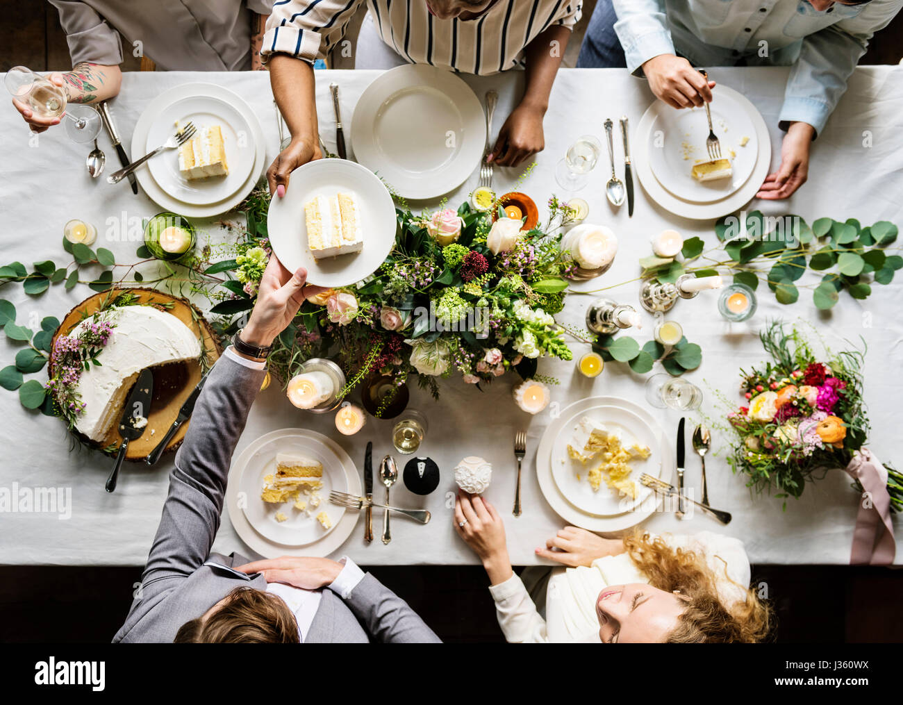 Groom Handing Cake to Friends on Wedding Reception Stock Photo - Alamy