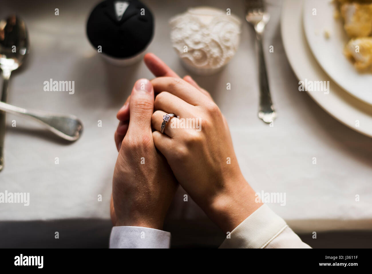 Bride and Groom Holding Hands on Wedding Reception Stock Photo - Alamy