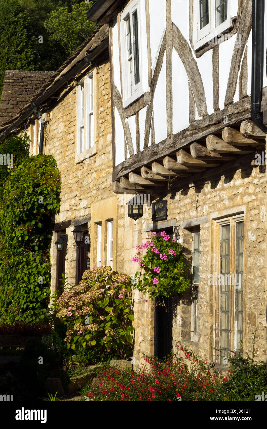 Quaint stone cottages line the street in Castle Combe, The Cotswolds ...