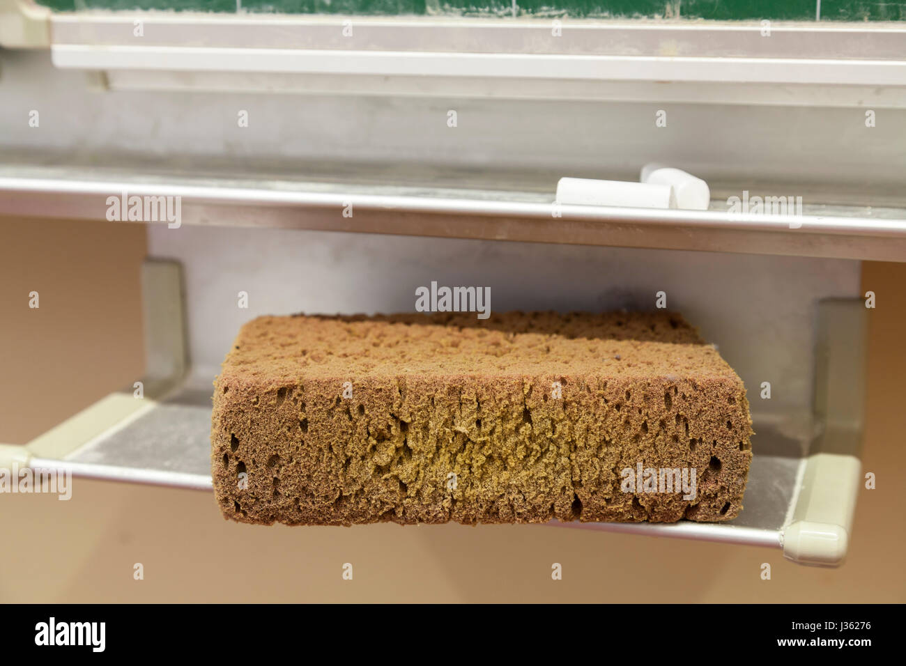 Sponge and chalk at blackboard Stock Photo - Alamy