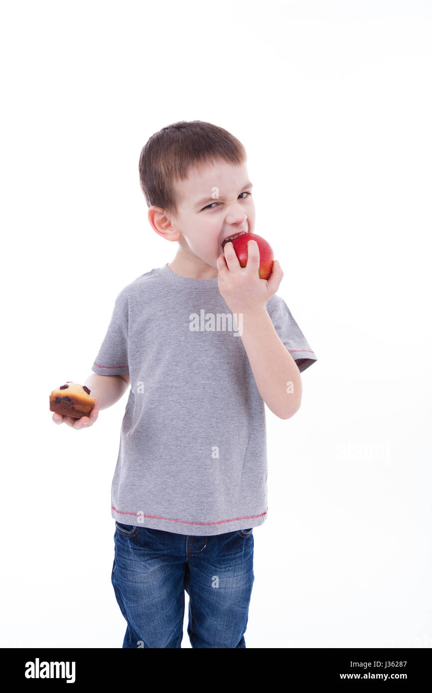 little boy with food isolated on white background - apple or a muffin ...