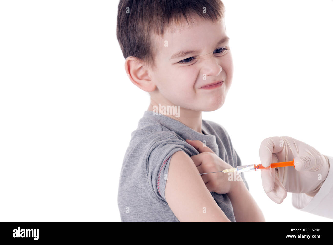 Doctor giving a child injection in arm on isolated image Stock Photo ...