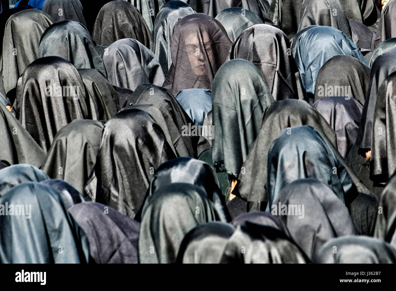 A transparent black veil lets appear the face of a woman among the ...