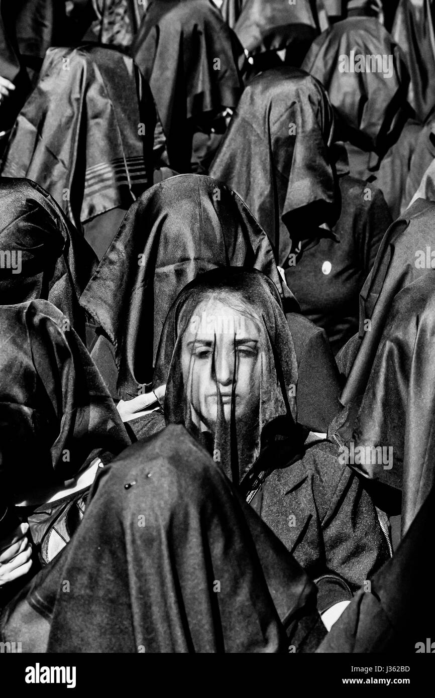 A transparent black veil lets appear the face of a woman among the ...