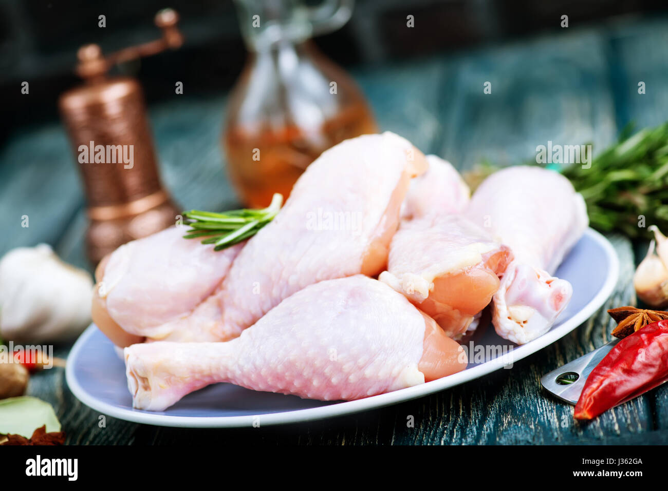 raw chicken legs on the metal plate Stock Photo - Alamy