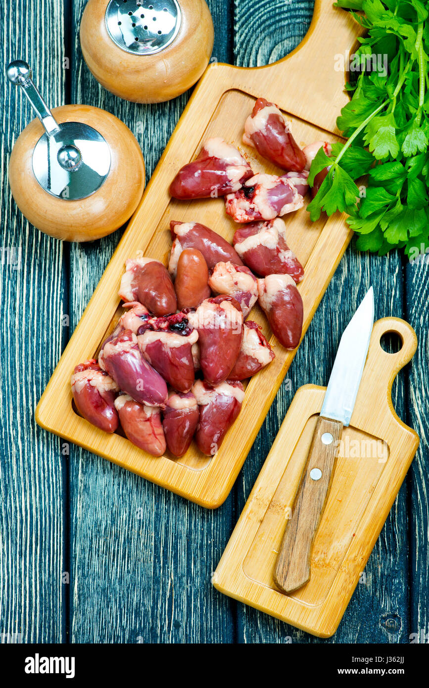 chicken heart on board and on a table Stock Photo - Alamy