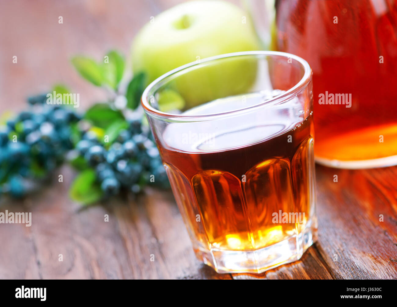 fresh juice in glass and on a table Stock Photo - Alamy