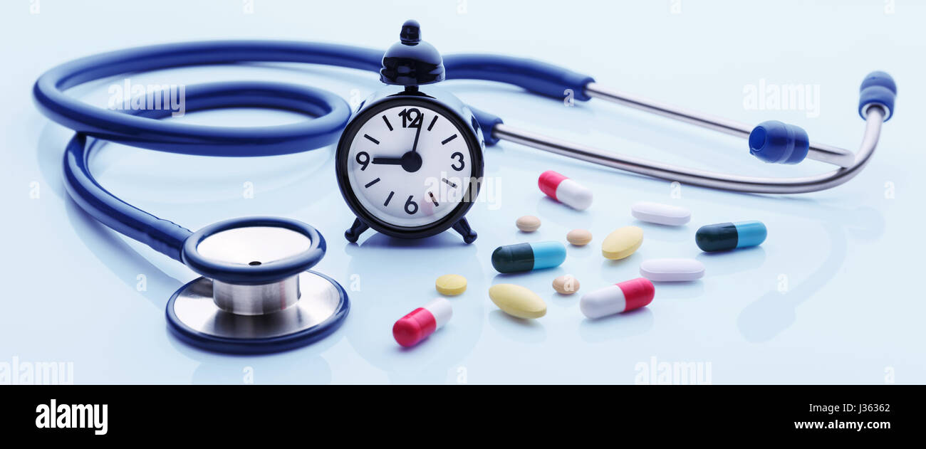 Time for health checkup with stethoscope and medicine on blue ...