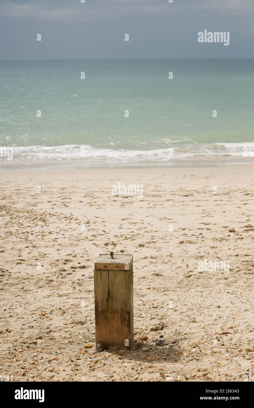 Wooden post in the sand on the beach Stock Photo - Alamy
