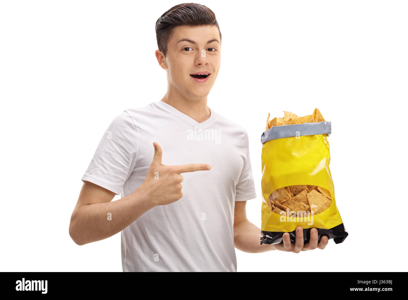 Teenager holding a bag of chips and pointing isolated on white ...