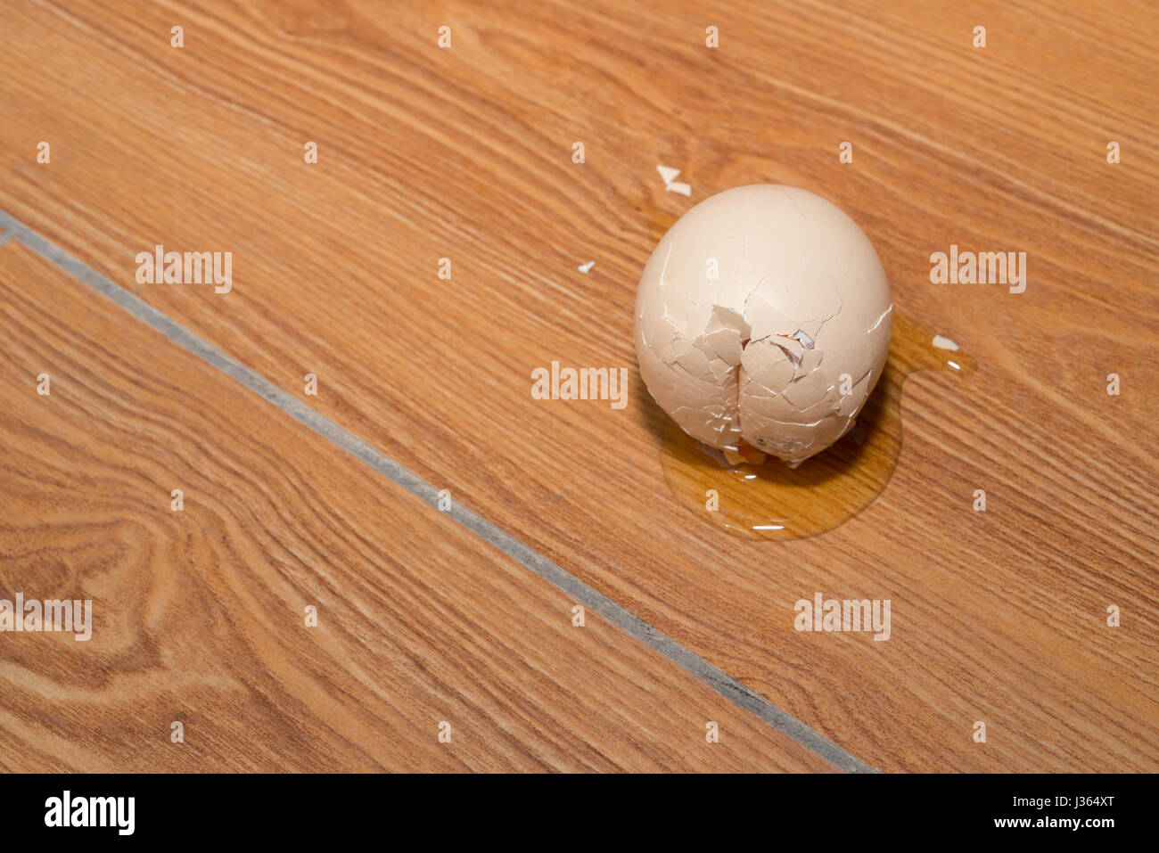 broken egg on floor Stock Photo - Alamy