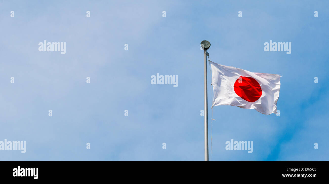 japan flag with blue sky background Stock Photo - Alamy