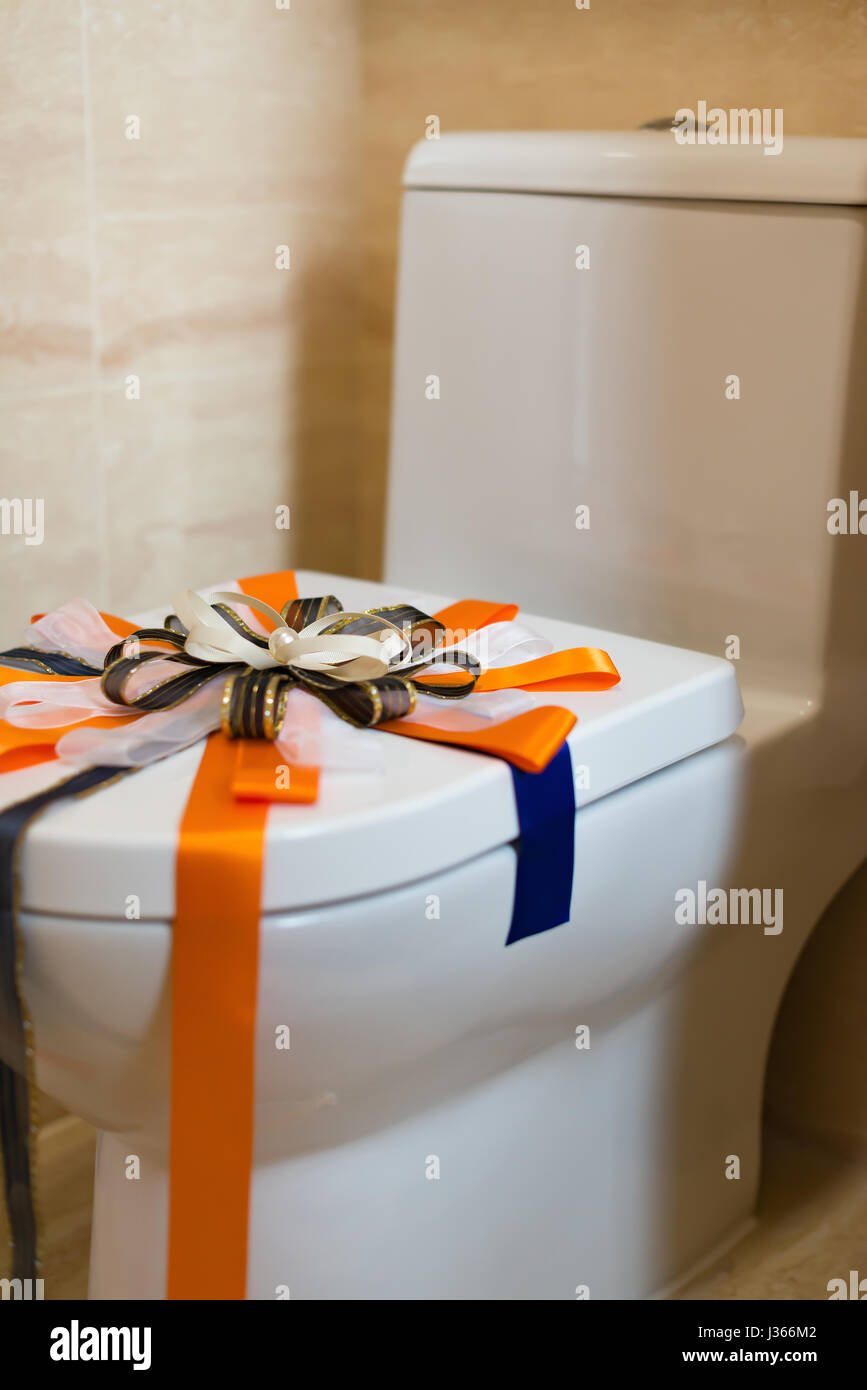 wrapped closestool as a present Stock Photo - Alamy