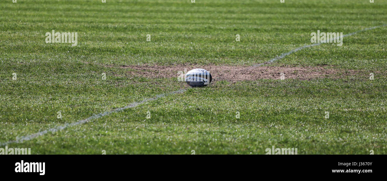 Rugby Ball sitting on centre line of rugby pitch Stock Photo - Alamy