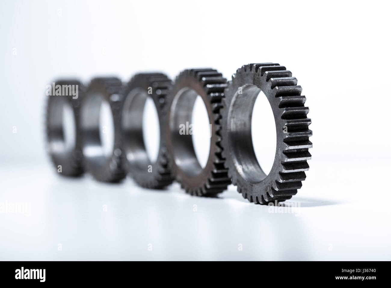 Machine Gears lined up in a row Stock Photo - Alamy