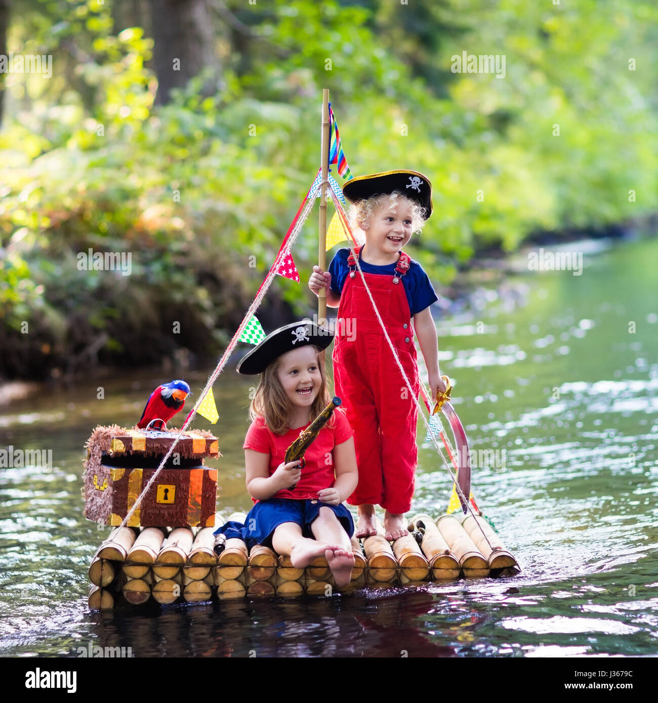 Kids dressed in pirate costumes and hats with treasure chest ...