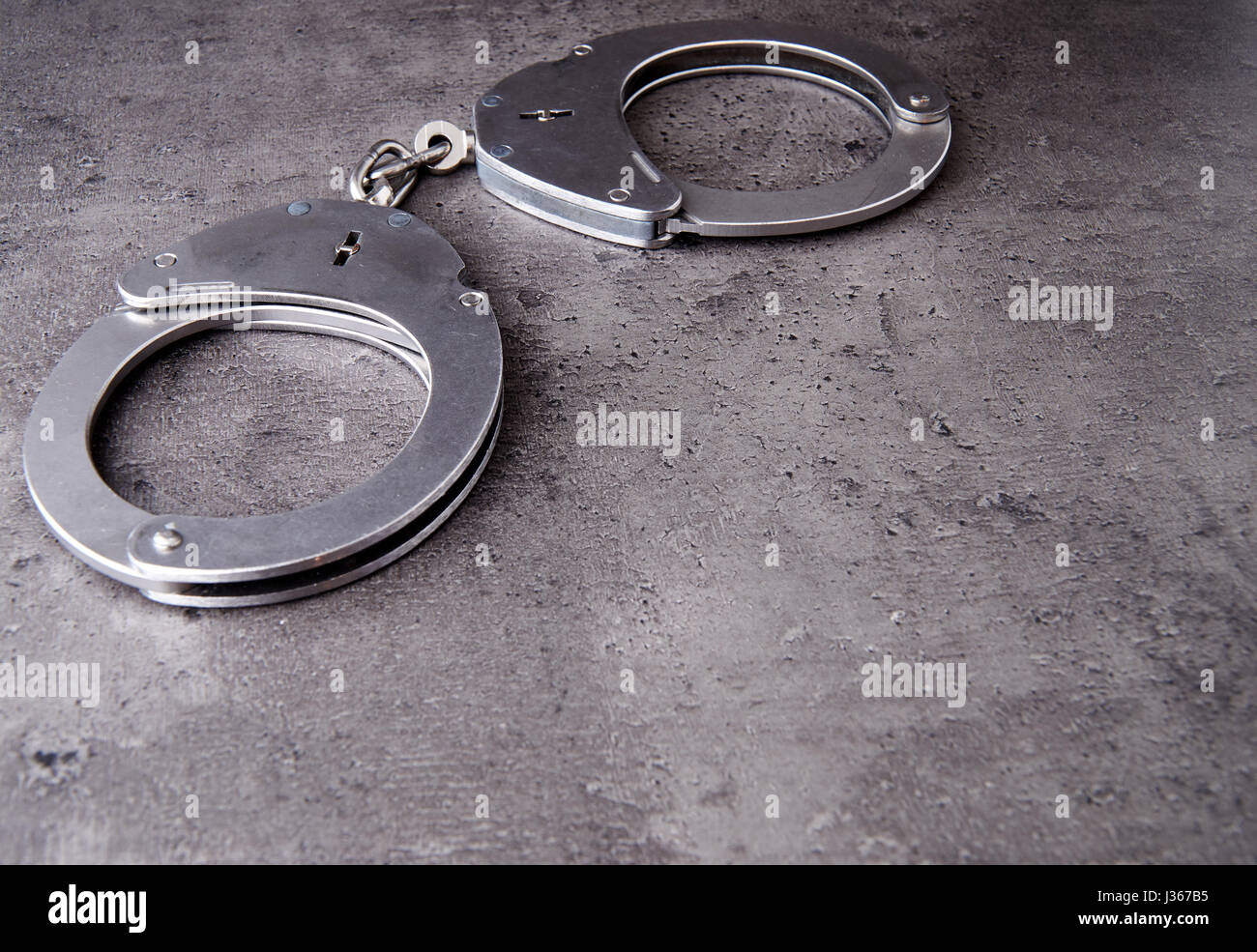 German police handcuffs on rough grey background with copy space Stock ...