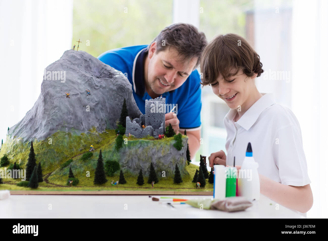 Father and son work on model building school project. Kids and parent ...