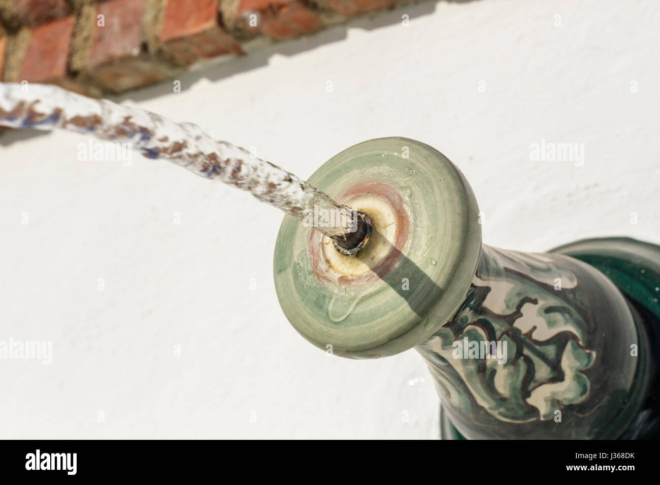 Detail of water jet falling into a swimming pool, viewed from bellow ...