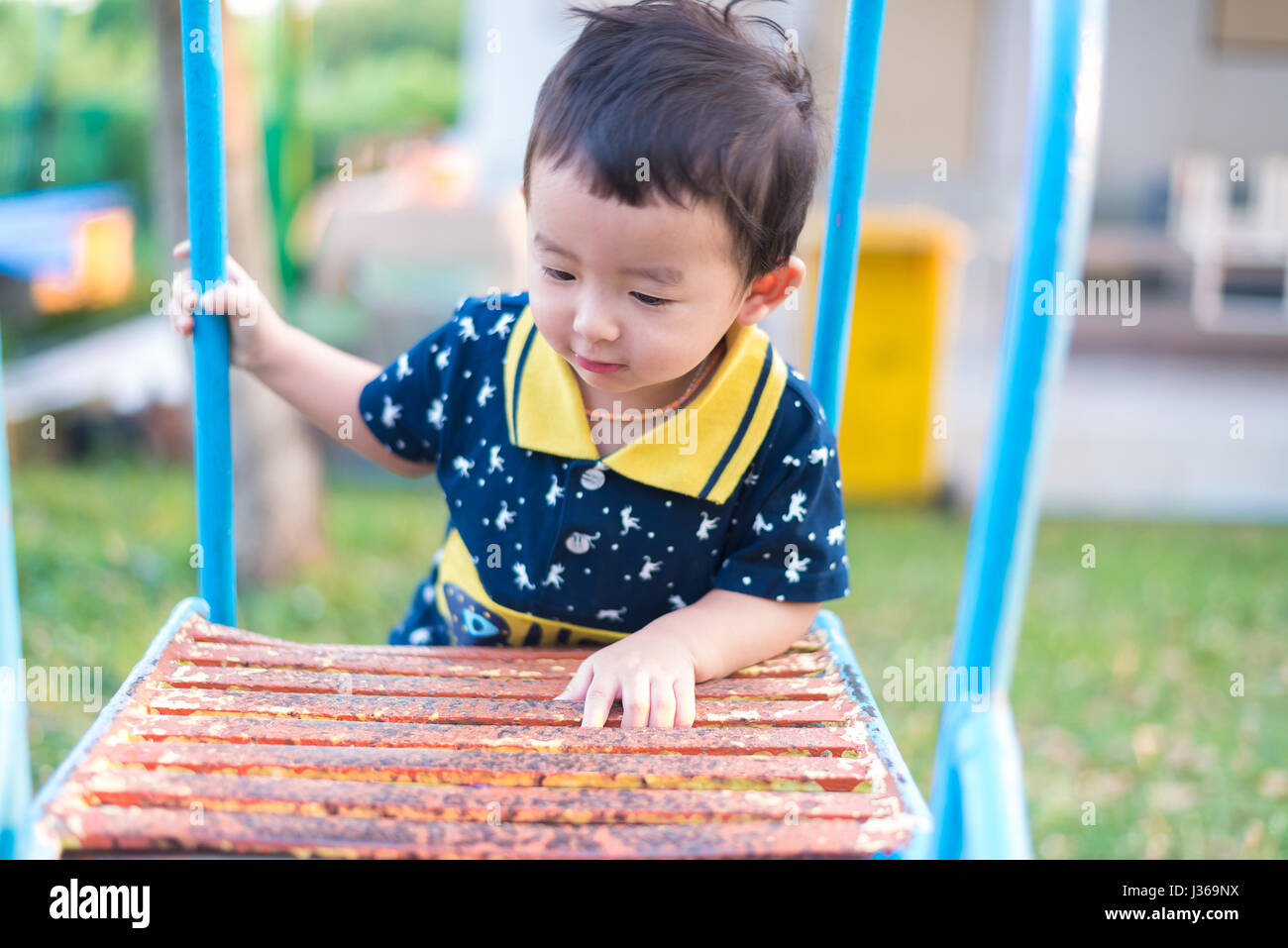 Asian kid goes up the stairs in the park. concept of growing up. step ...