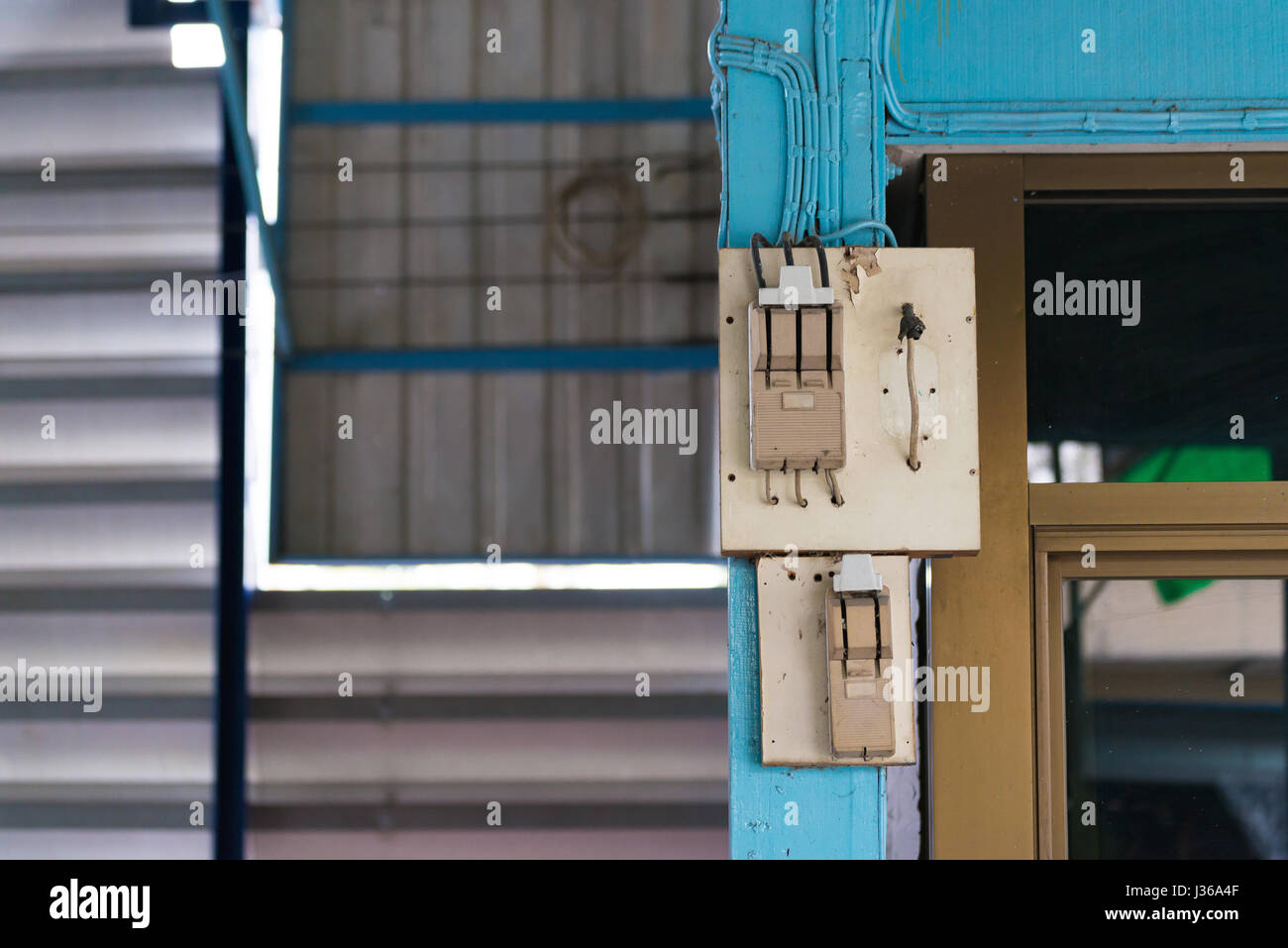 Old electrical power safety breaker with socket outlet on the wall ...