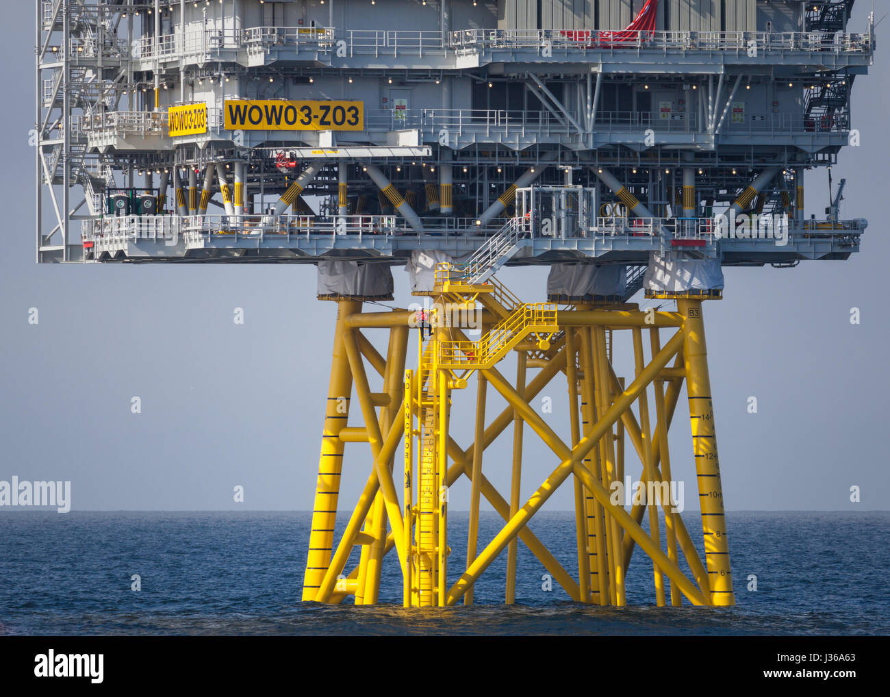 A worker climbing substation Z03 on Walney Extension Offshore Wind Farm ...