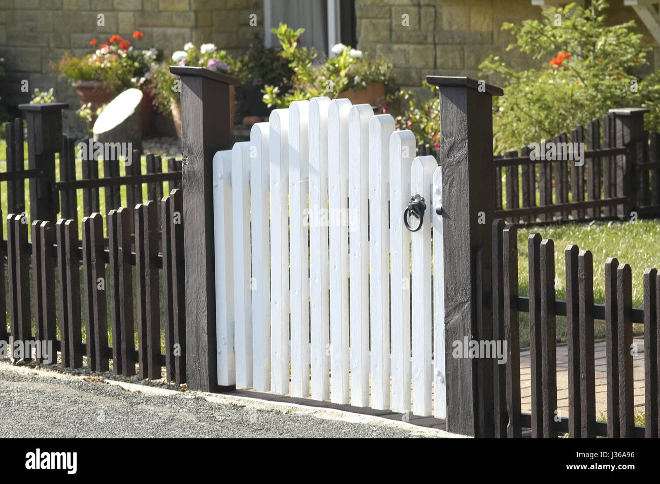 white wooden gate and low fence around a garden Stock Photo - Alamy