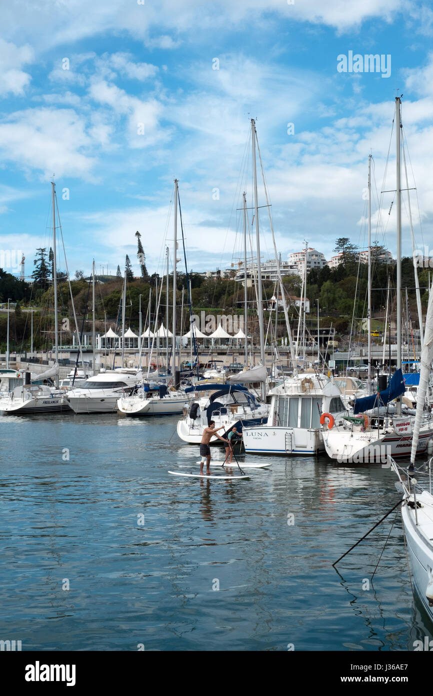 Two surf board users paddle into the marina at Funchal, Madeira Stock ...