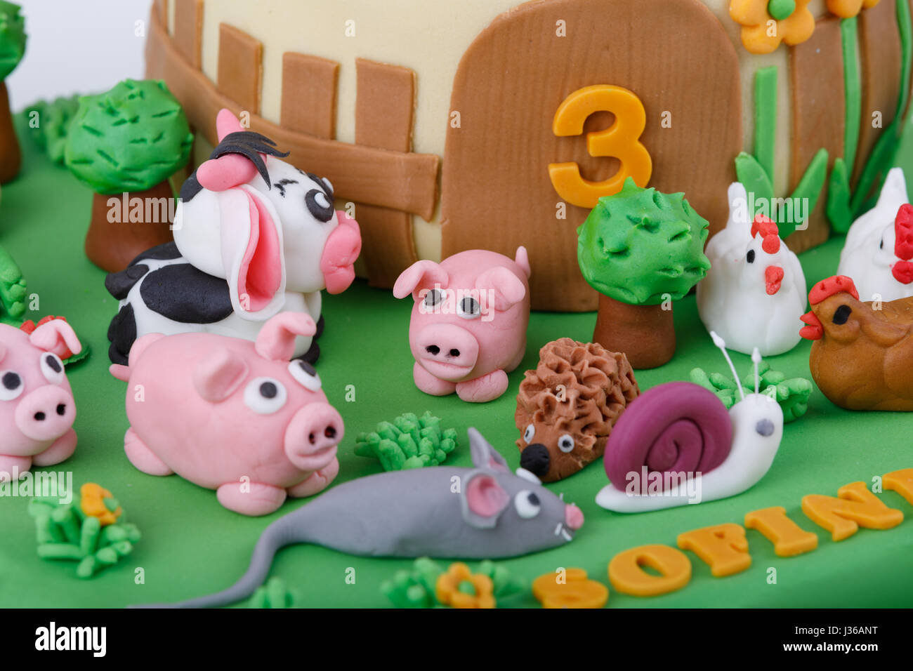detail of birthday cake with farm marzipan animals and number 3 Stock ...