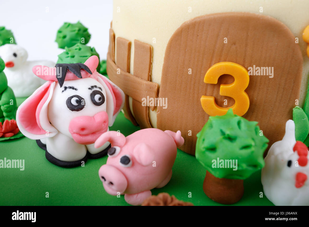 detail of birthday cake with farm marzipan animals and number 3 Stock ...