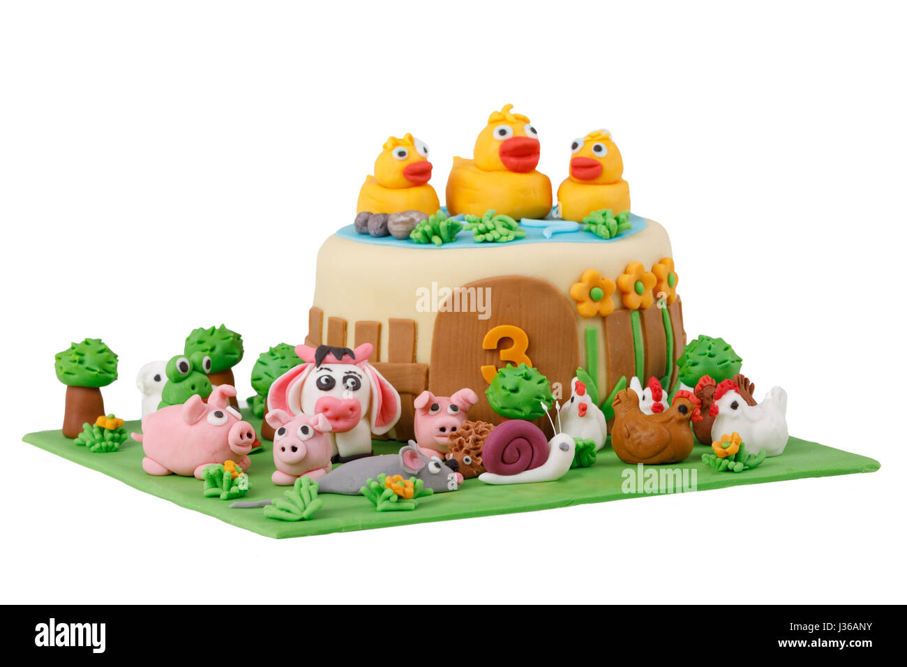 birthday cake with farm marzipan animals and number 3 isolated on white ...