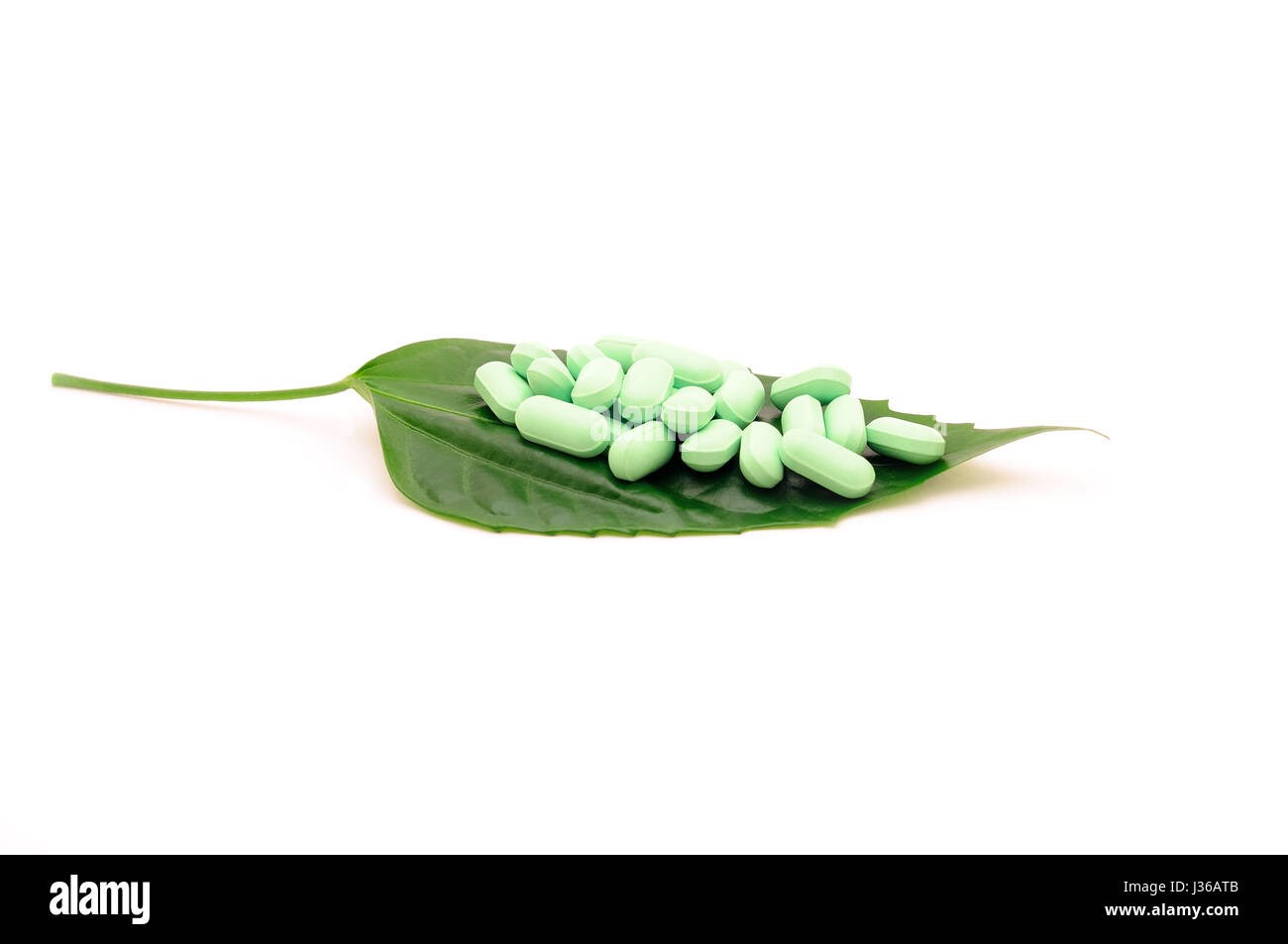 Green pills on a leaf Stock Photo - Alamy
