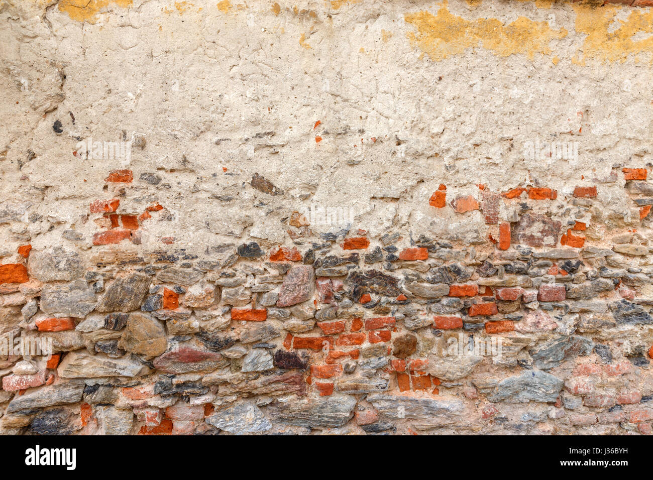 Old worn brick and stone wall texture background Stock Photo - Alamy