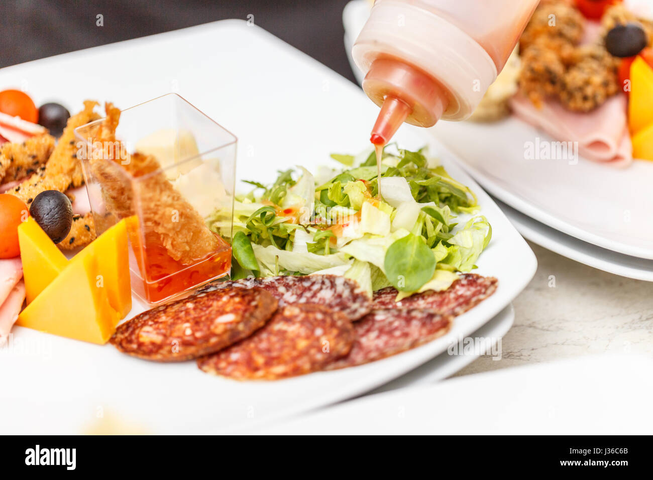 Chef in restaurant kitchen decorating an appetizer plate Stock Photo ...