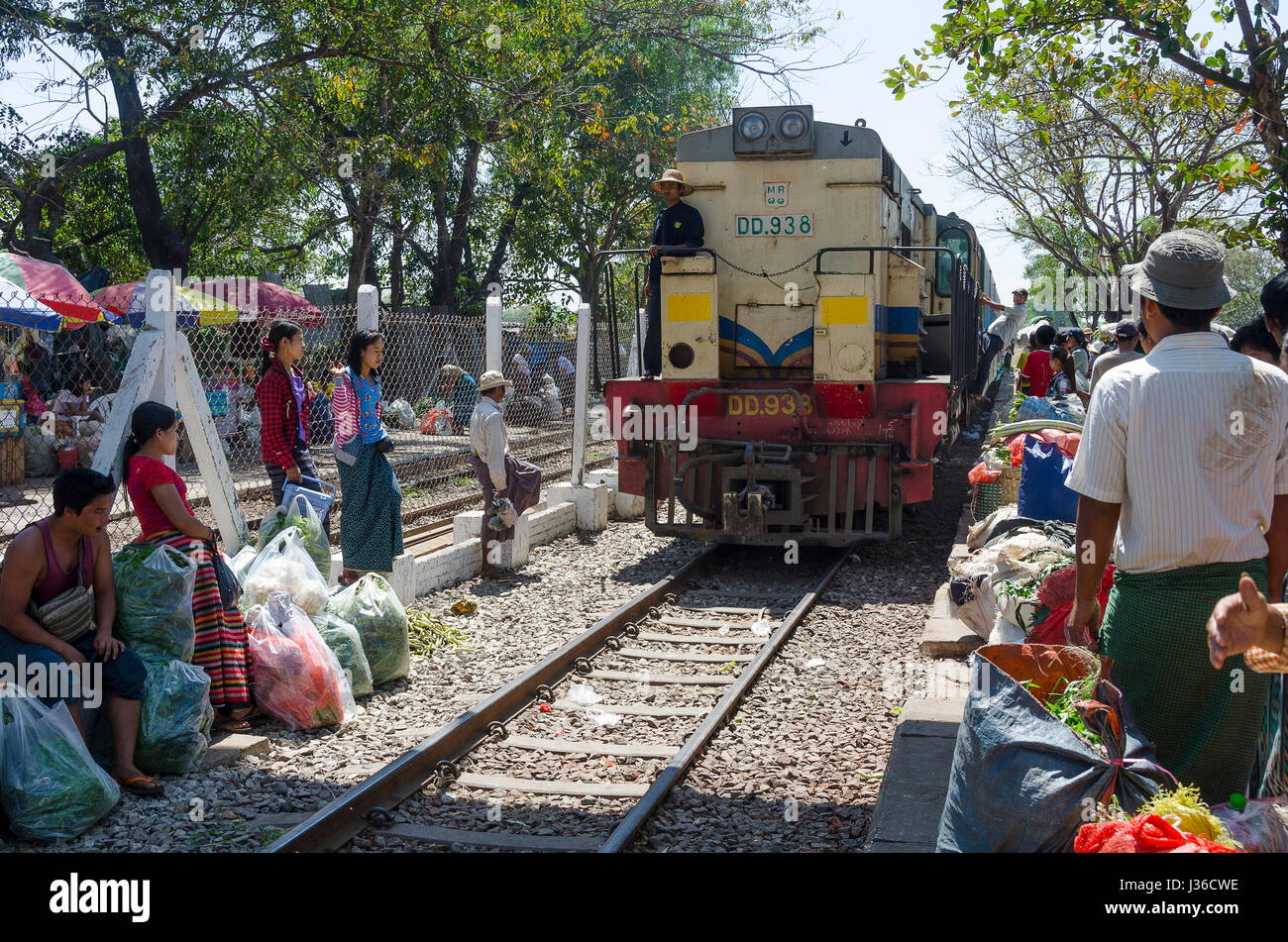 Suburban train entering Dan Ying Don station and market, Yangon ...