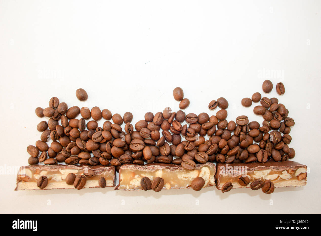 Sweet candy with a nut in coffee grains on a white Stock Photo - Alamy