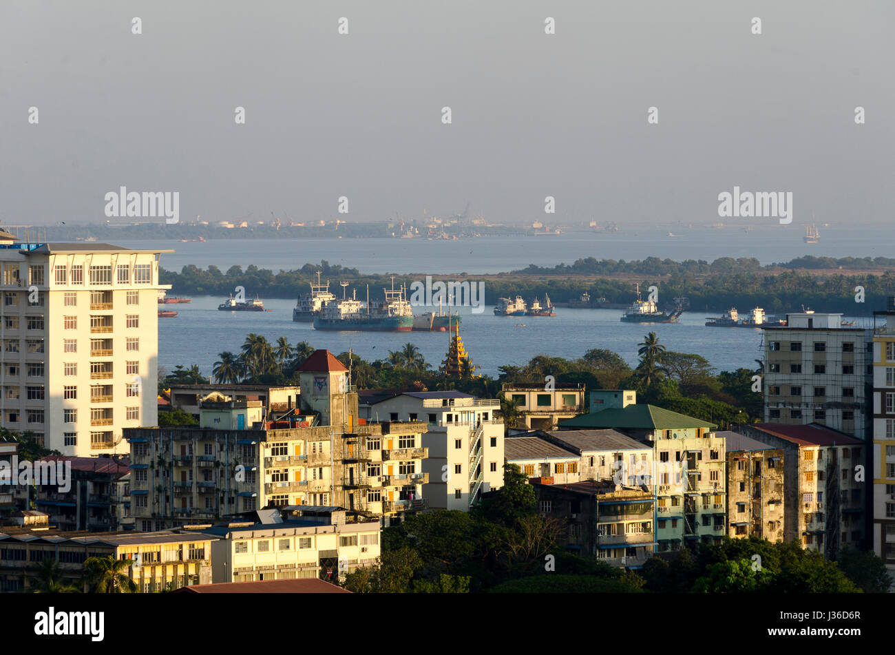 Ships in Yangon river and apartment blocks, Yangon, Myanmar Stock Photo ...