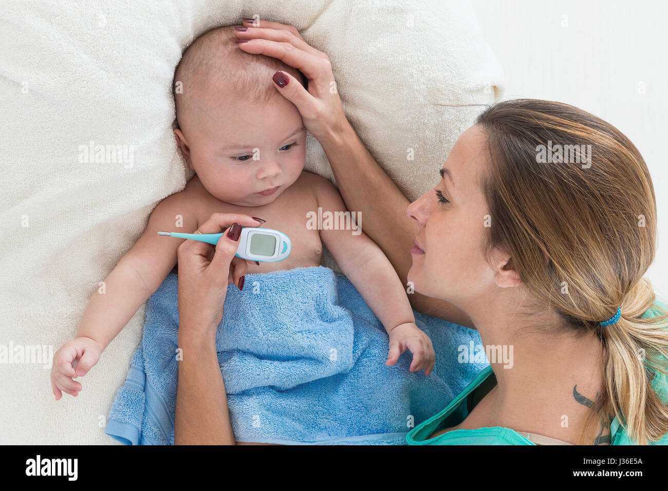 Mother taking baby temperature hi-res stock photography and images - Alamy